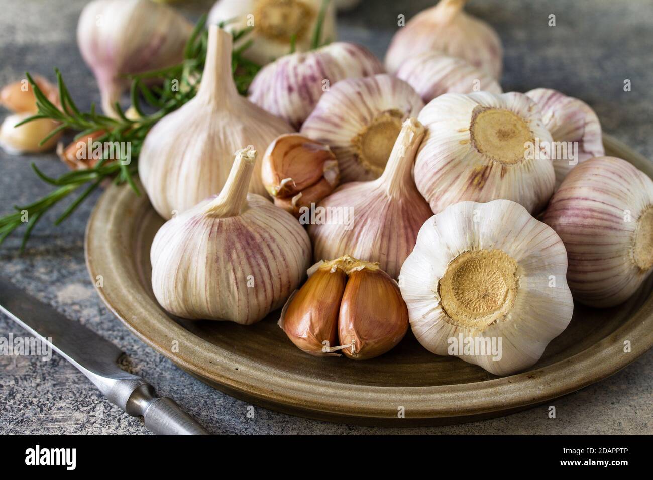 Healthy food. Garlic Cloves and Bulb close-up on a stone or slate table ...