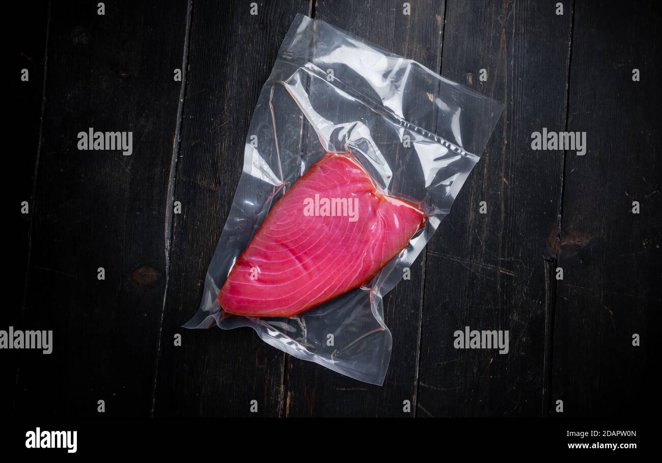 Cold Smoked Tuna Fillet vacuum-packed. Seafood on a wooden background ...