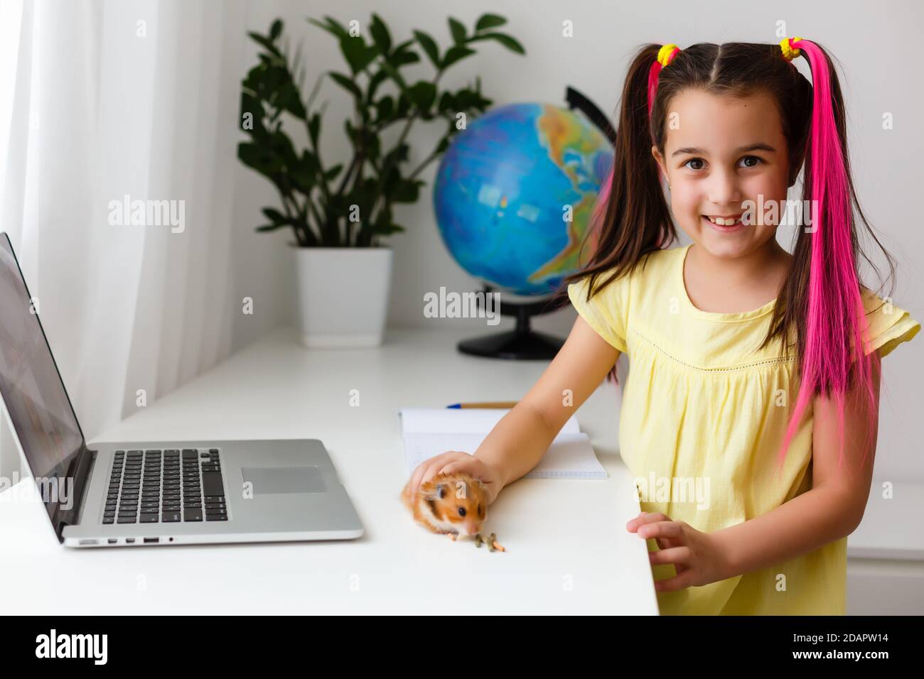 Educate at home. Child girl make homework with pet hamster. Funny ...