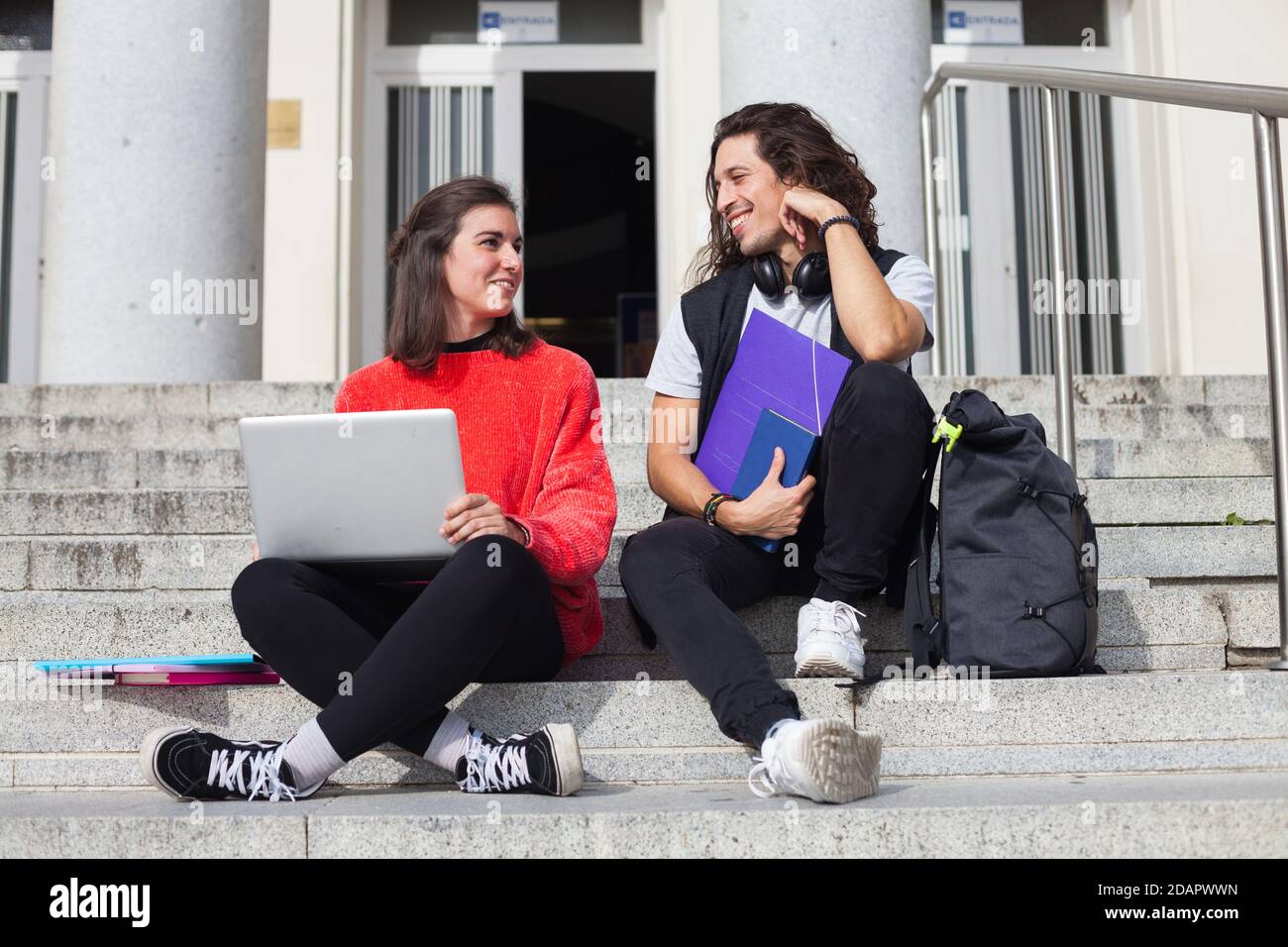 Two young students studying outdoor wearing mask during coronavirus ...