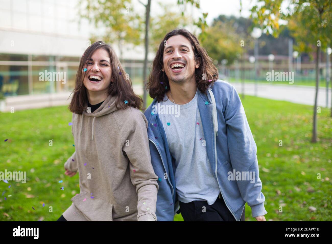 two friends having fun celebrating with confetti outdoor Stock Photo ...