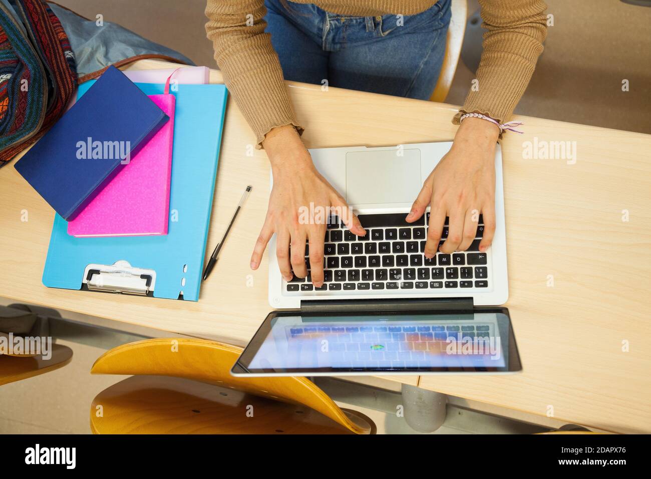 Female university student using laptop in classroom Stock Photo - Alamy