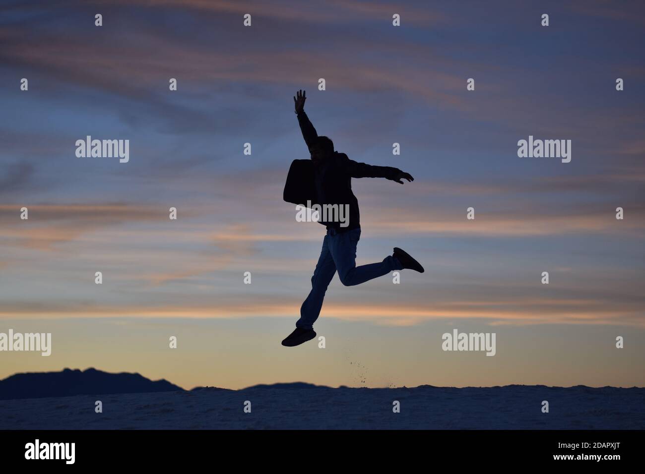 Young energetic happy man jumping high on mountain background and ...