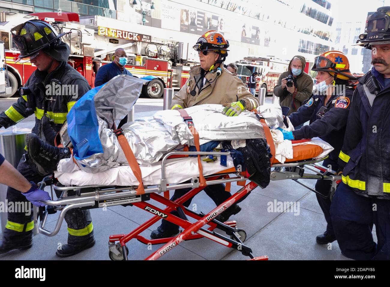 An injured construction worker seen on a stretcher.A scaffolding ...