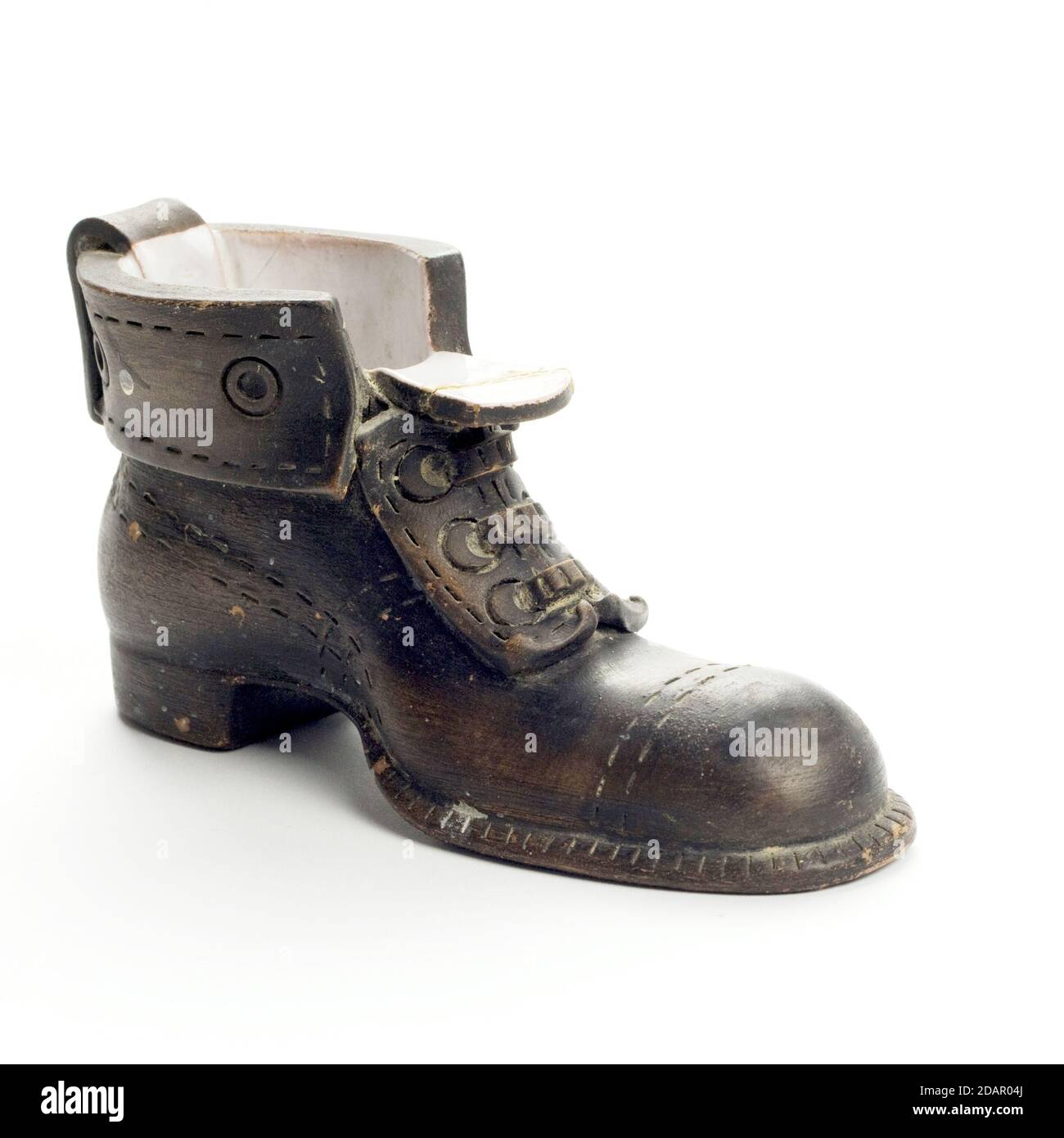 Vertical shot of a ceramic shoe sculpture on a white background Stock ...