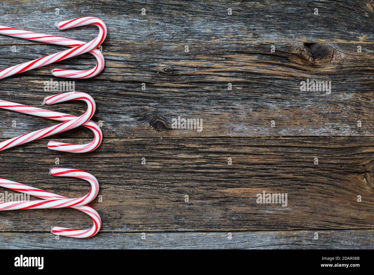 Rustic wood with candy canes Stock Photo - Alamy