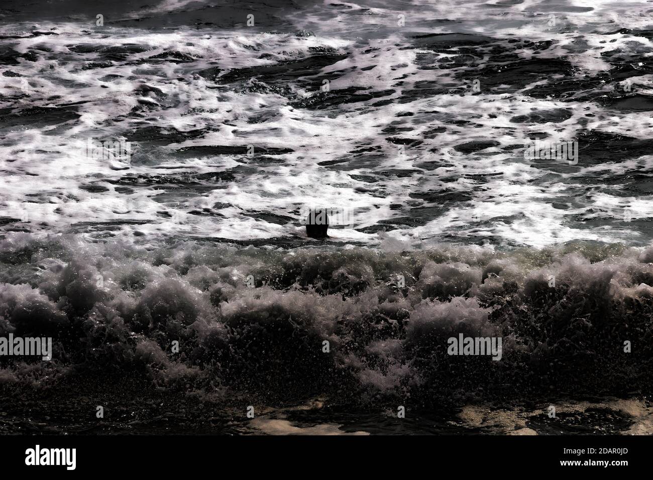 Black anonymous unrecognizable silhouette in a rough sea. Danger storm ...