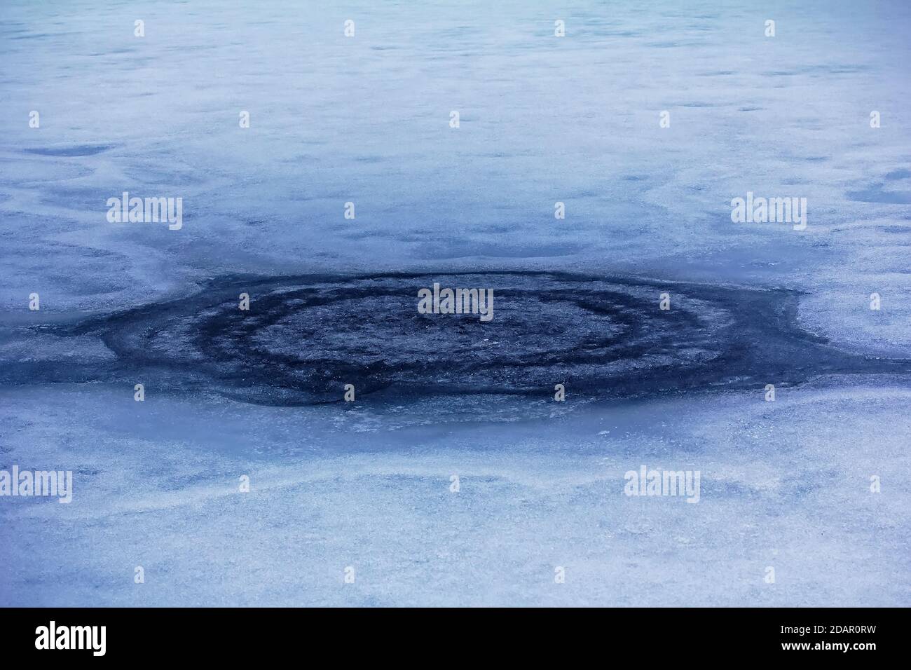 For Earth watchers. First thawing hole in ice - hole is round as ...