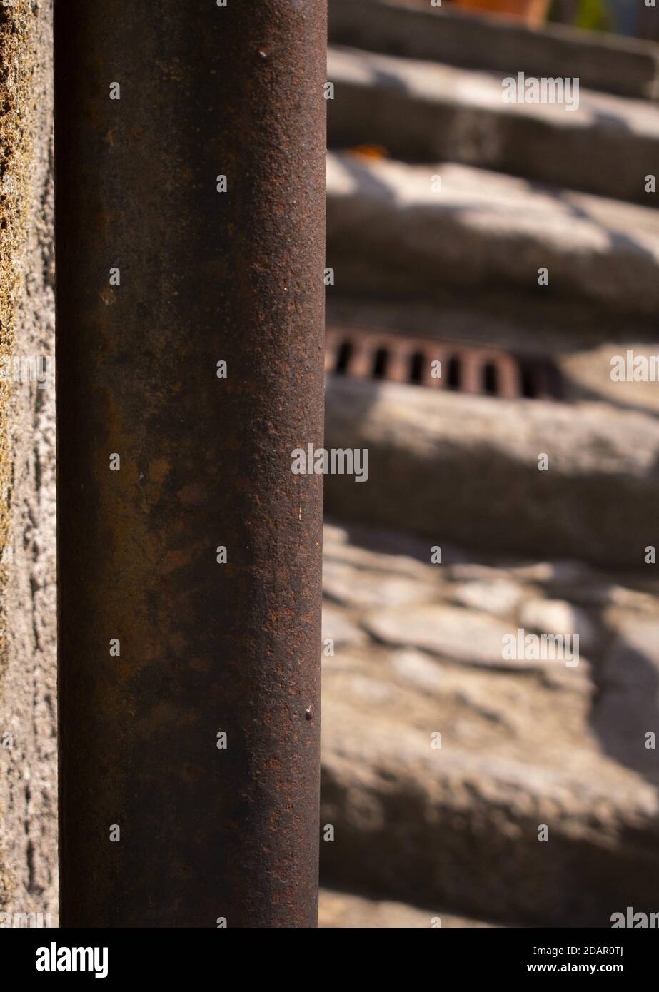 Vertical shot of a pipe going up on the old building exterior wall ...