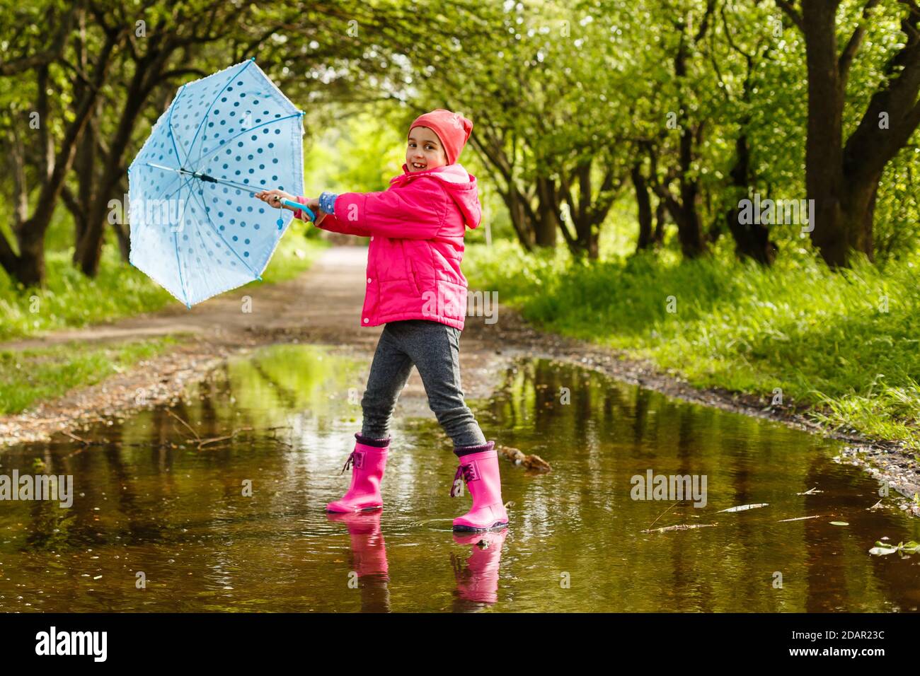 little girl riding bike in water puddle Stock Photo - Alamy