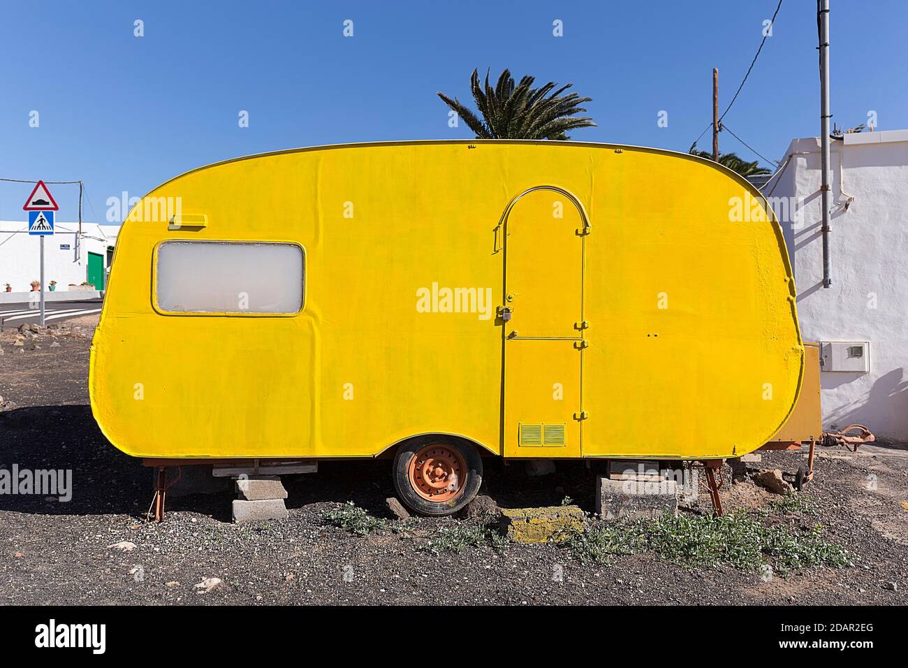 Old, yellow painted caravan, jacked up, Lanzarote, Spain Stock Photo ...