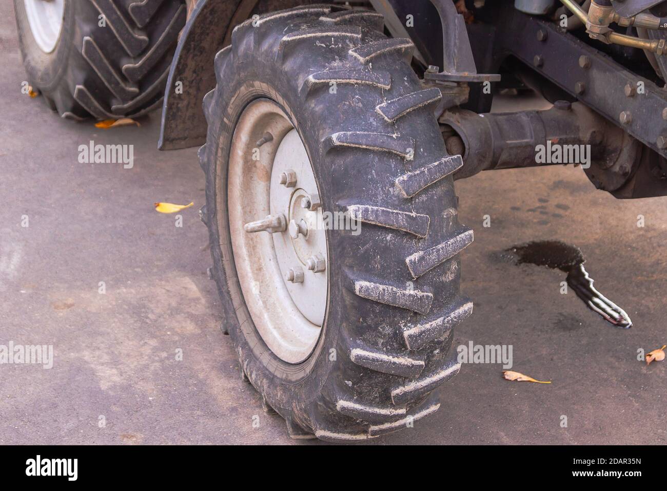 tractor wheel with suspension on asphalt Stock Photo - Alamy