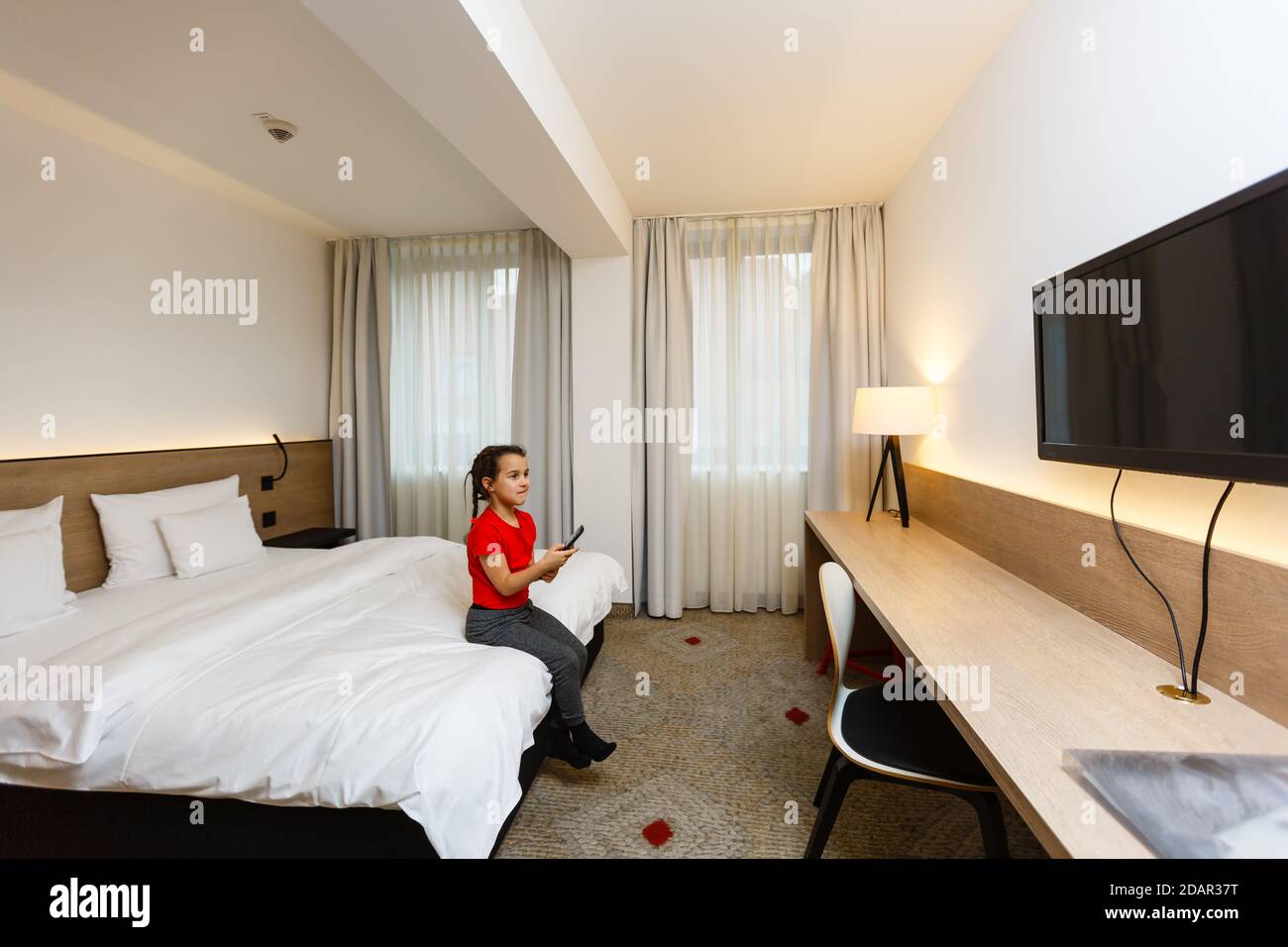 Little girl holding tv remote control Stock Photo - Alamy Little girl holding tv remote control Stock Photo - Alamy
