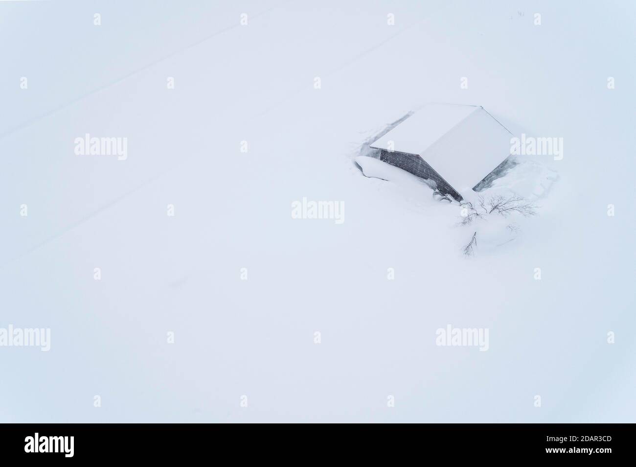 Aerial view of a lonely wooden house in the snow in winter, Muonio ...