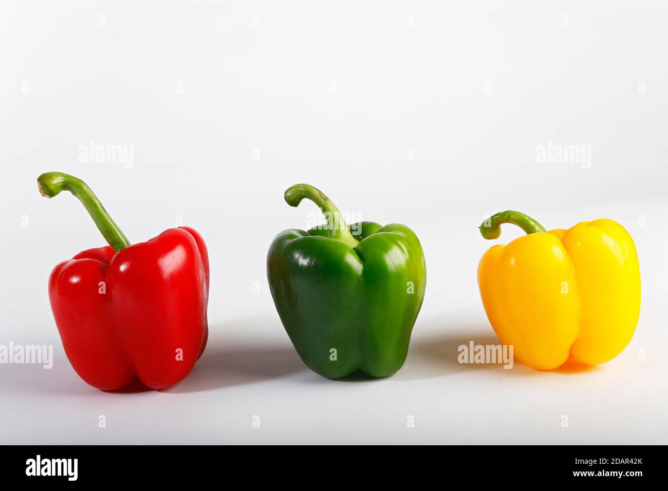 Red, yellow and green peppers (Capsicum annuum), vegetables, studio ...