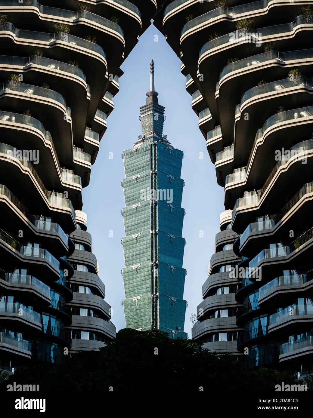 View of Taipei 101 Tower, framed by a high-rise building, Taipei, Taiwan Stock Photo - Alamy