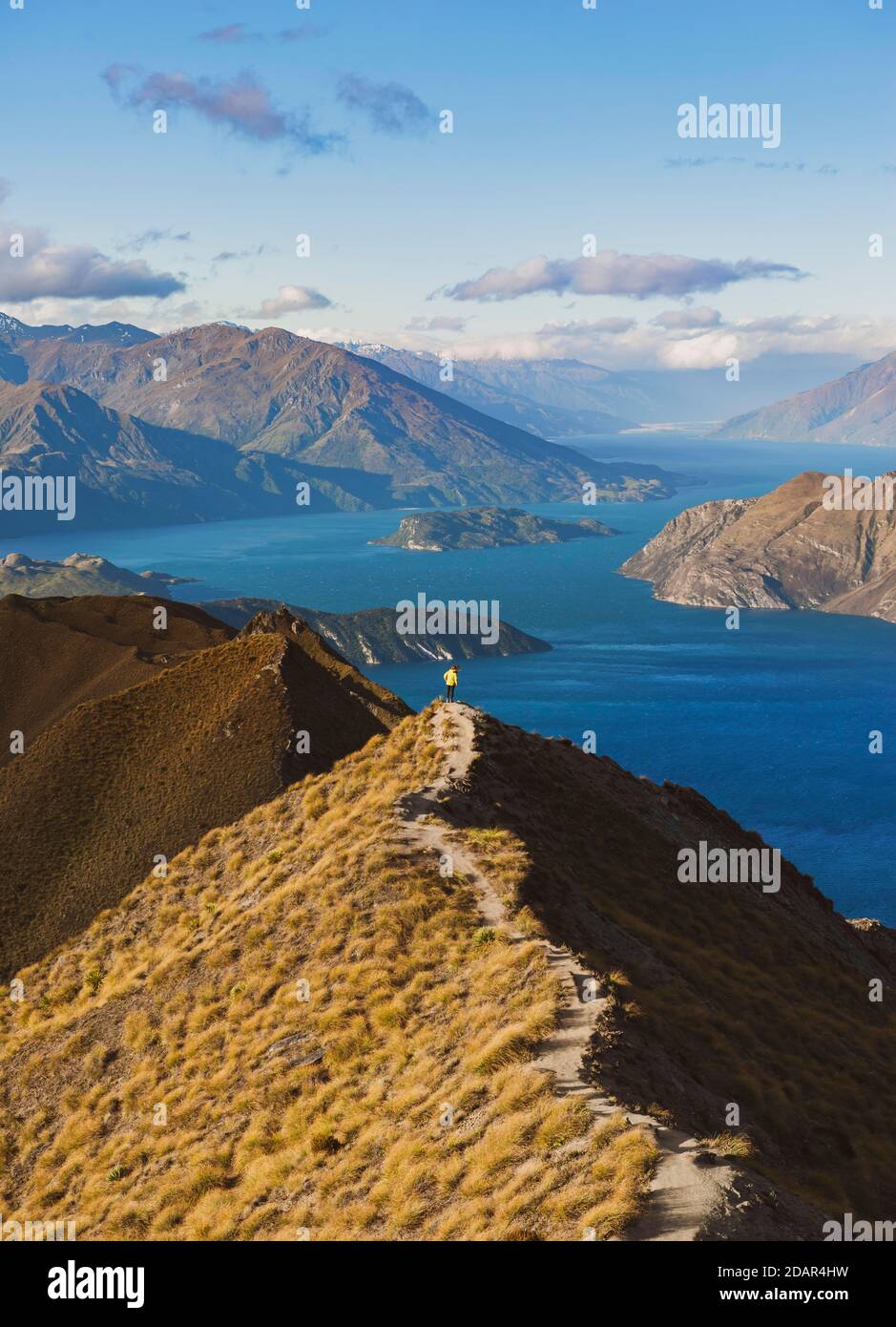 Hiker on the summit of Mount Roy, views of mountains and lake, Roys ...