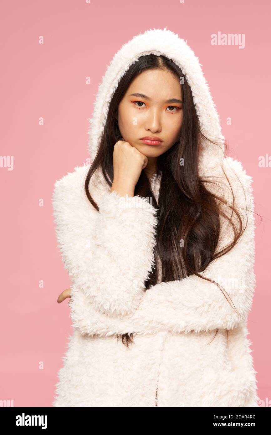 Sad woman in white sweater winter clothes pink background Stock Photo ...