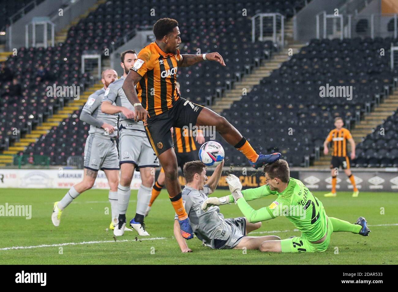 Goalkeeper Ben Garratt #24 of Burton Albion is brave diving at the feet ...