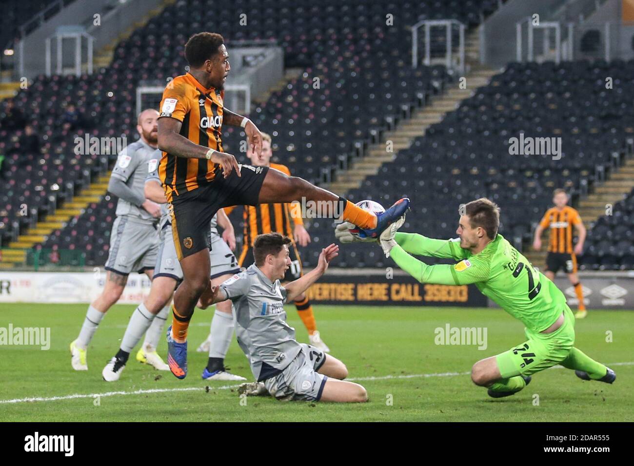 Goalkeeper Ben Garratt #24 of Burton Albion is brave diving at the feet ...