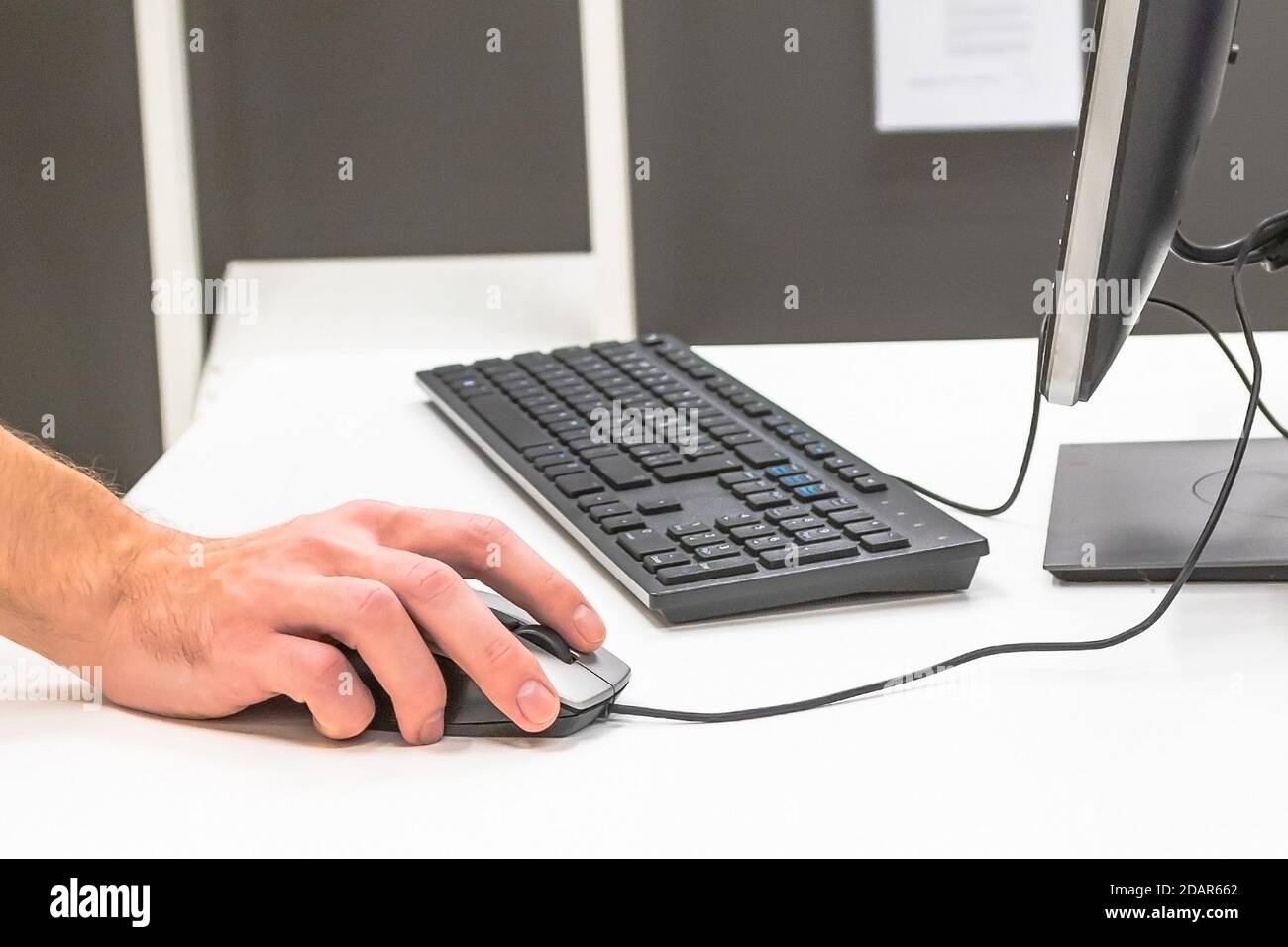a man's hand on a computer mouse Stock Photo - Alamy