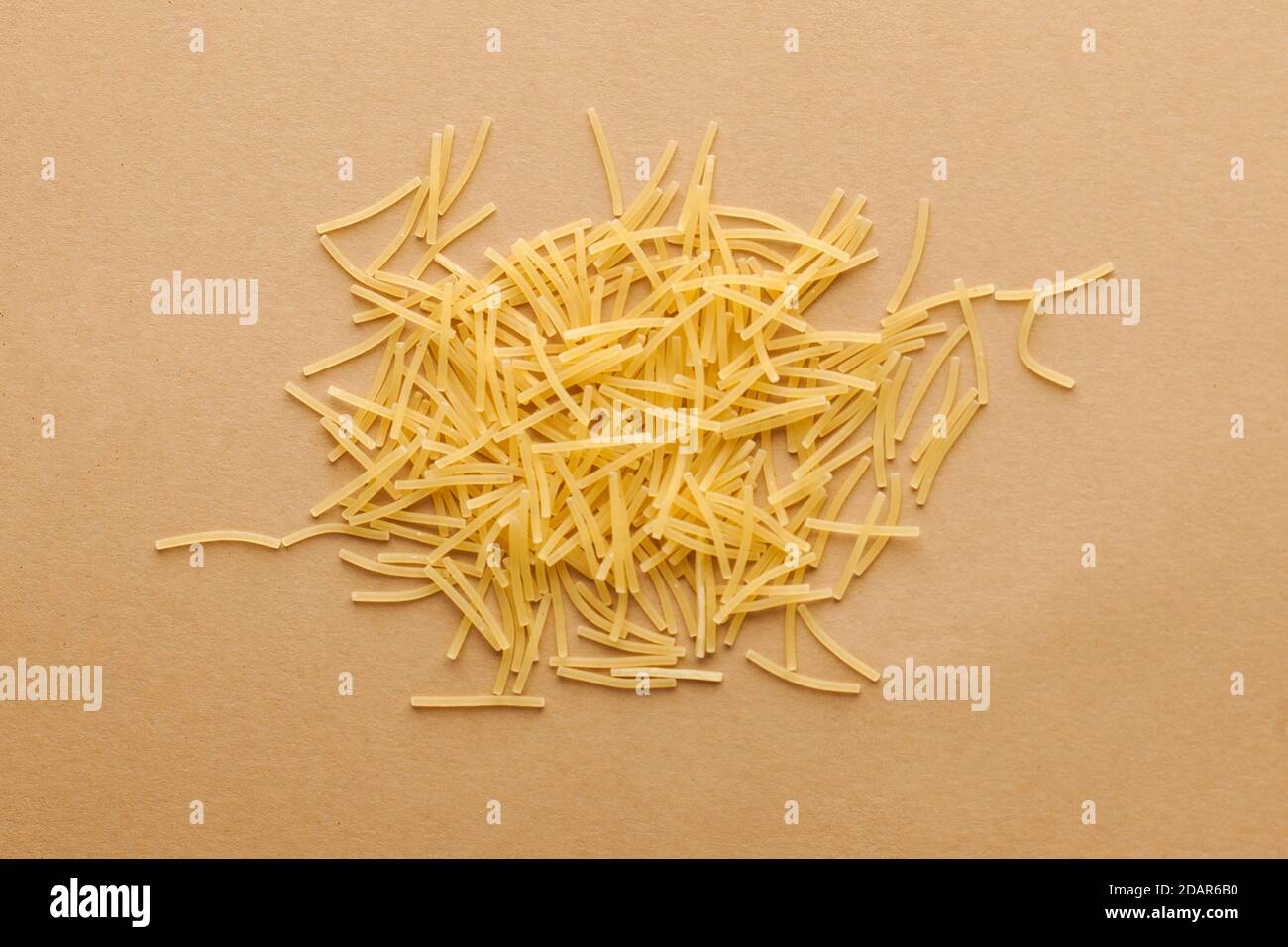 Italian short thin vermicelli on a brown background. Close-up, layout ...