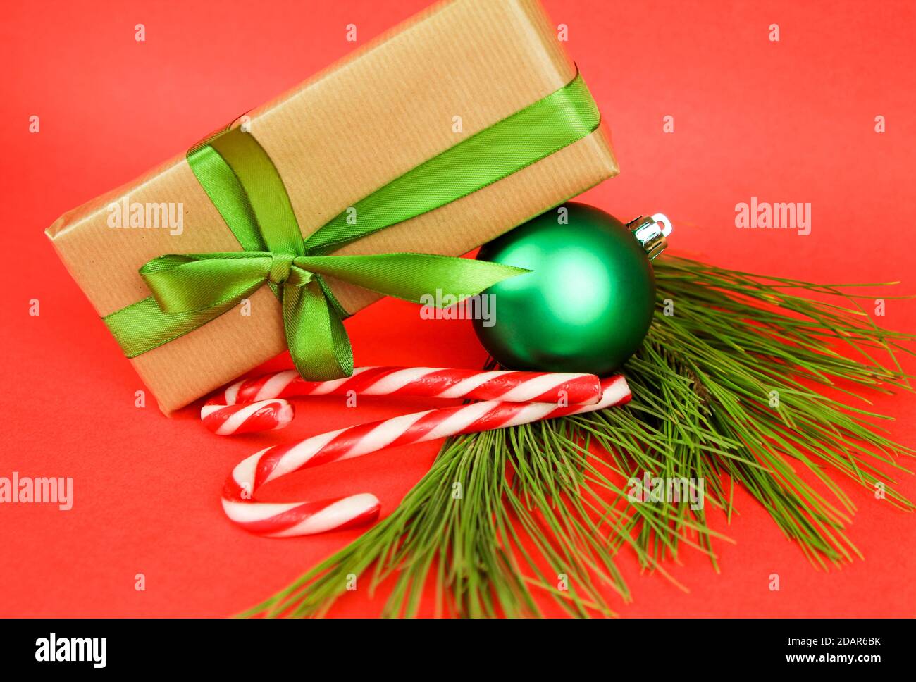 Gifts wrapped with brown paper and green bow next to Christmas ...