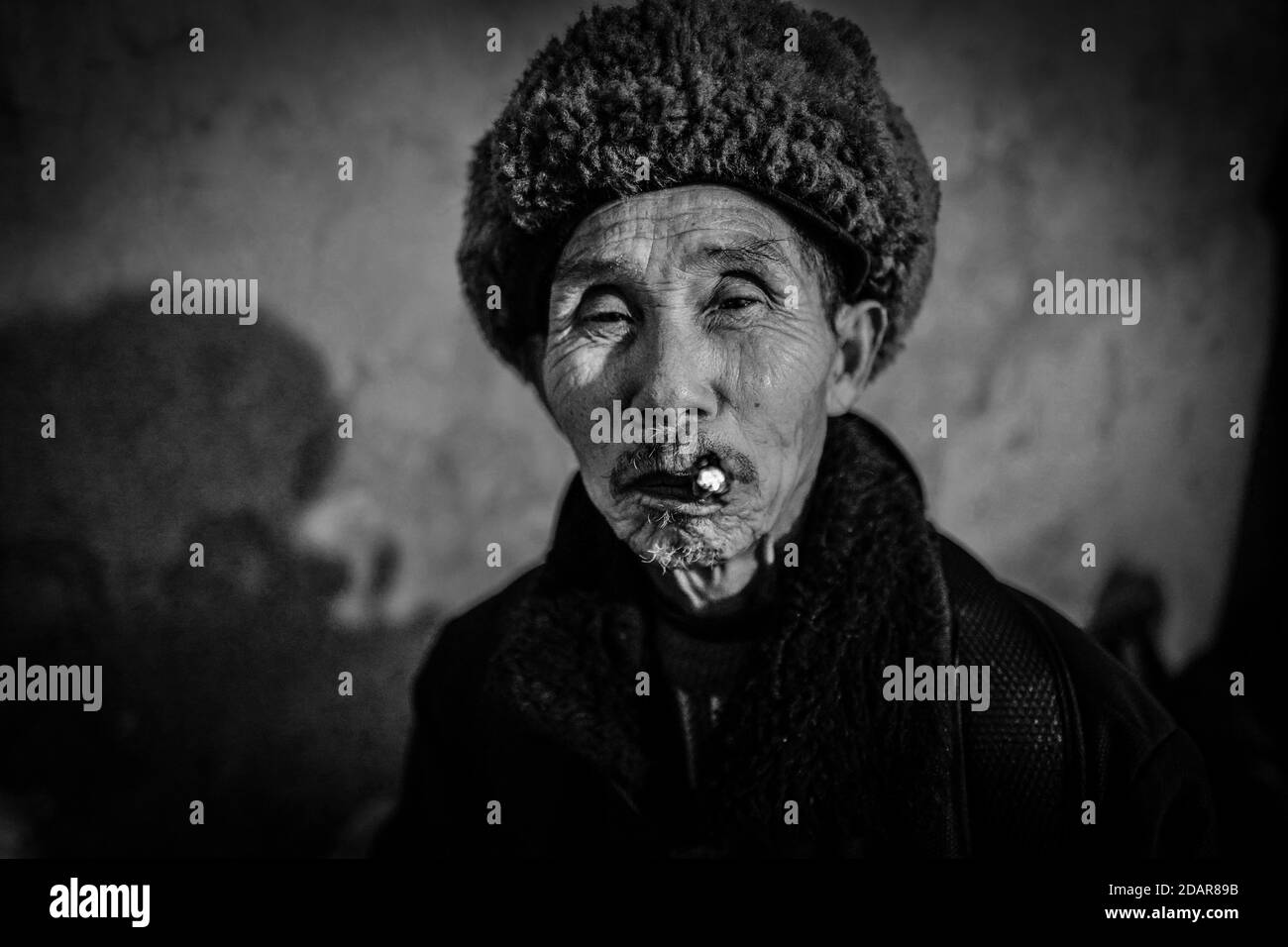 Portrait of a trader in a traditional market in Zhangjiajie, China ...