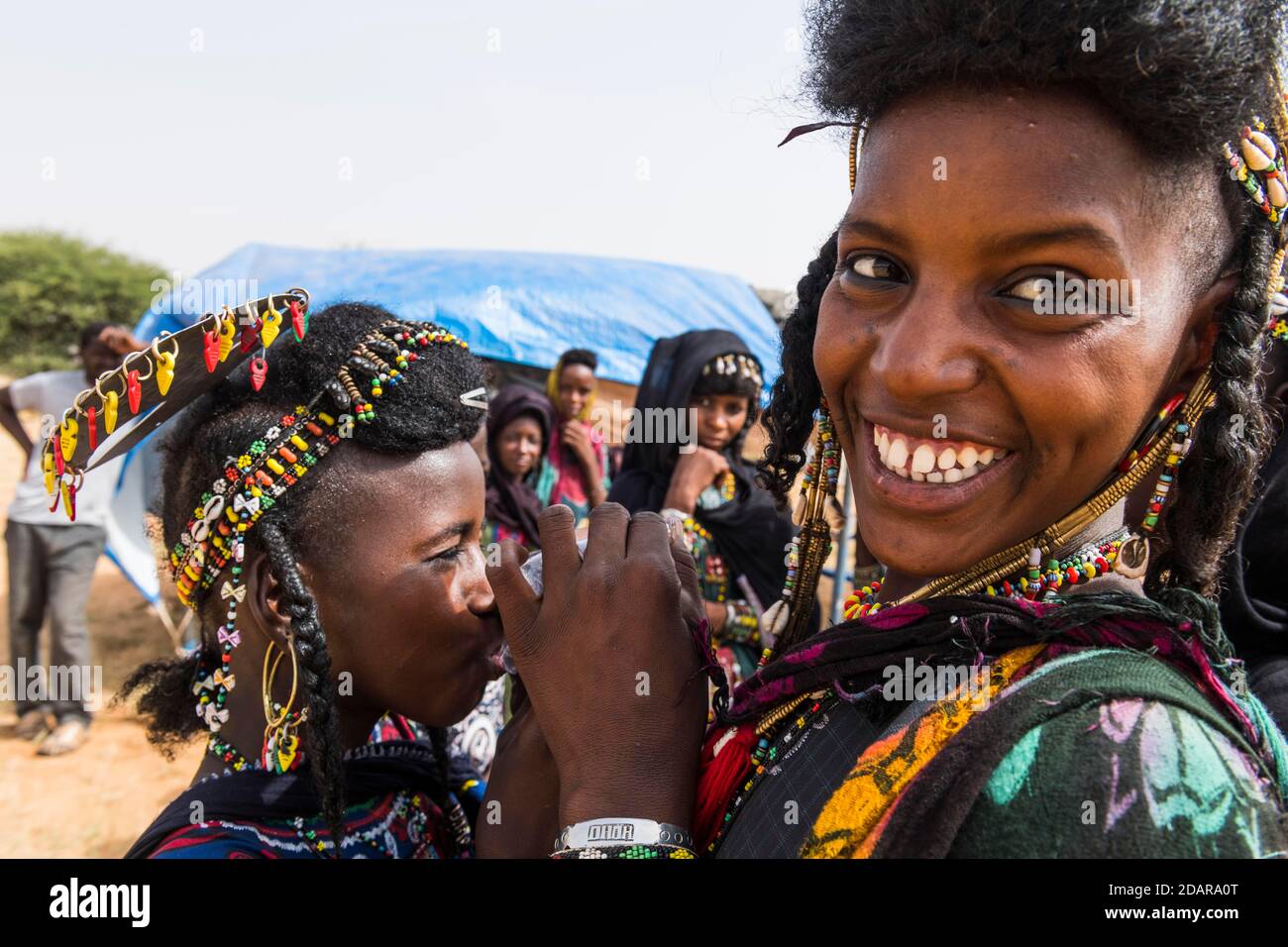 Two girls sharing a waterbag, Gerewol festival, courtship ritual ...
