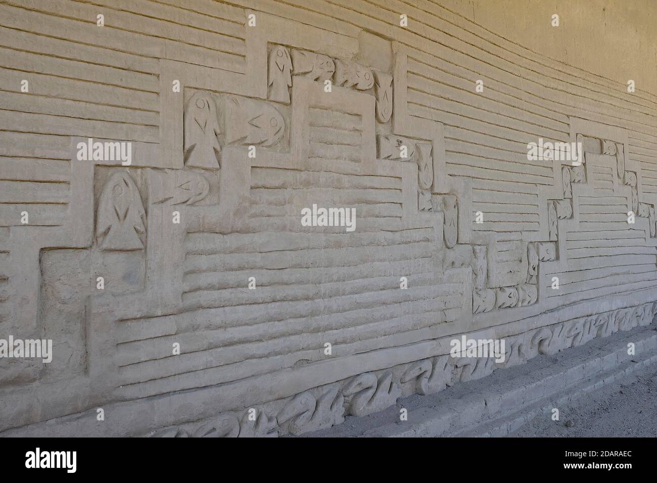 Relief with fishes on the wall of mud brick, adobe, ruins of Chan Chan ...