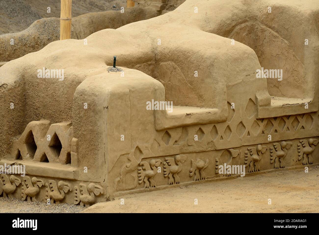 Artistic walls of mud brick, adobe with pelican relief, ruins of Chan ...