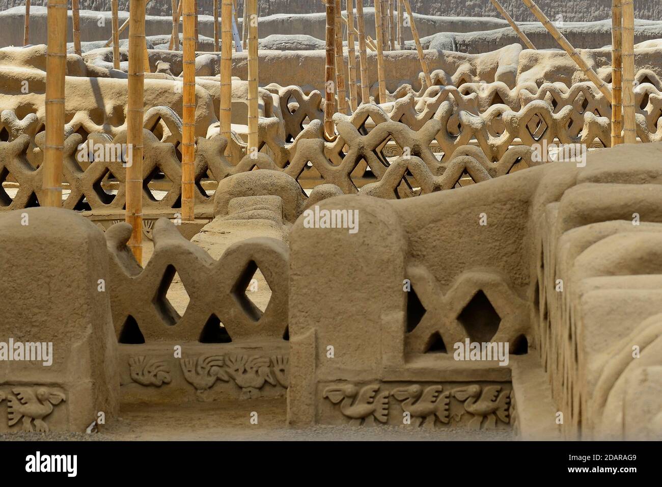 Artistic walls of mud brick, adobe with pelican relief, ruins of Chan ...