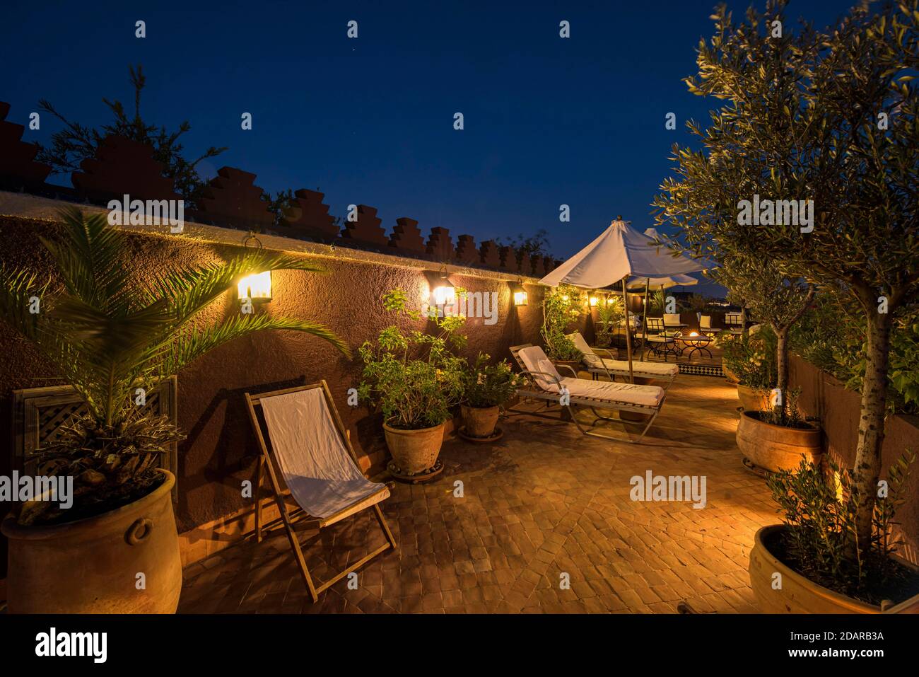 Roof terrace of a riad in the evening light, Moroccan hotel, Marrakesh ...