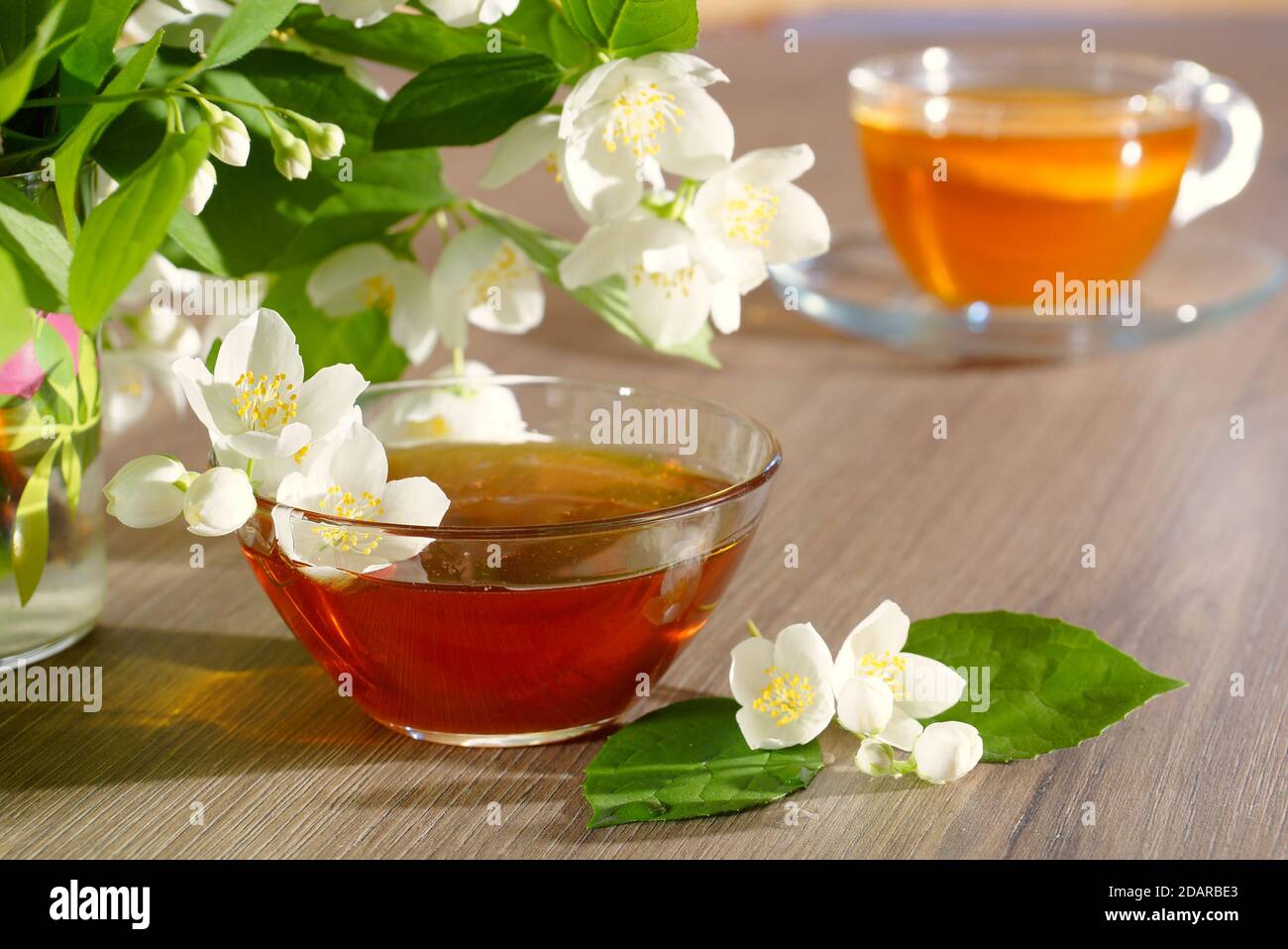 Flower honey, tea with lemon and jasmine blooming Stock Photo - Alamy
