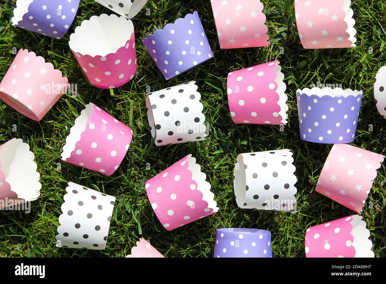 Multi-colored empty polka dot paper molds of white, purple and pink ...