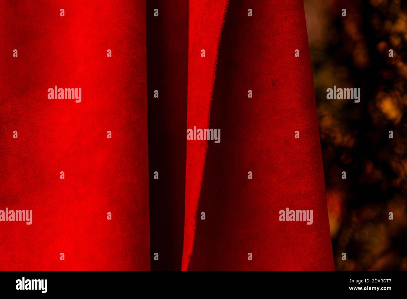 Red matte background of suede fabric, closeup. Velvet texture of ...