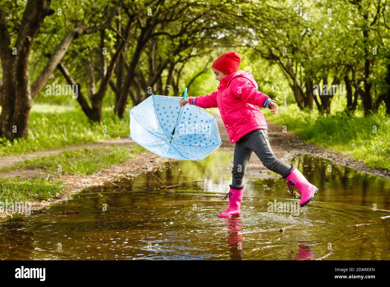 little girl riding bike in water puddle Stock Photo - Alamy