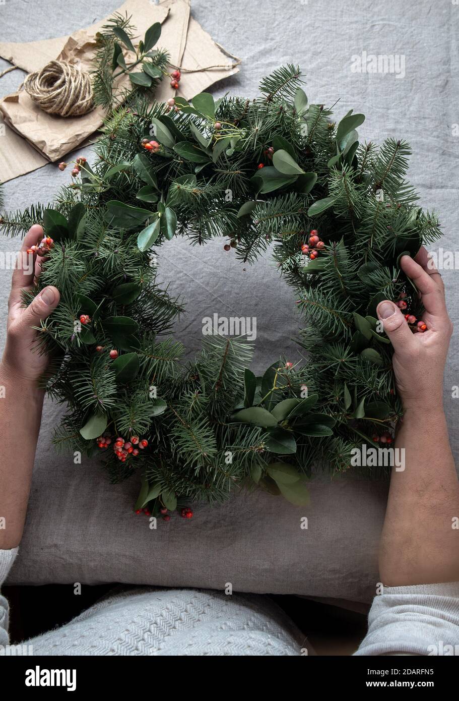 A man holding a Christmas wreath Stock Photo - Alamy