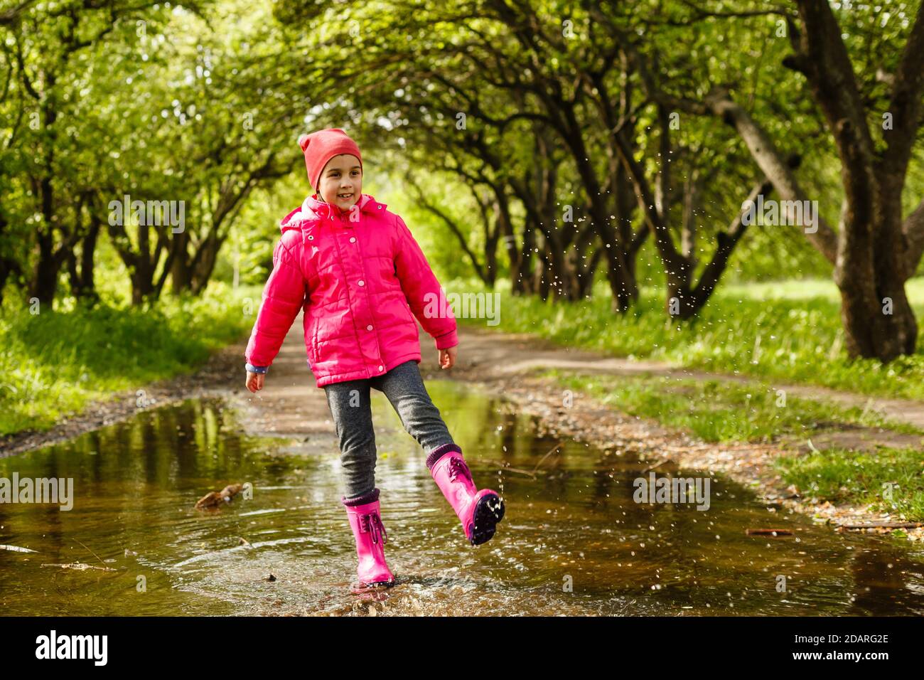 little girl riding bike in water puddle Stock Photo - Alamy