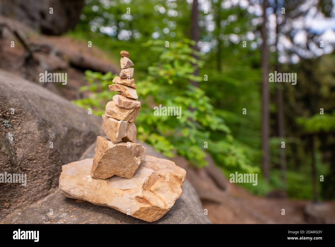 Closeup of small rocks balanced on each other in a forest Stock Photo ...