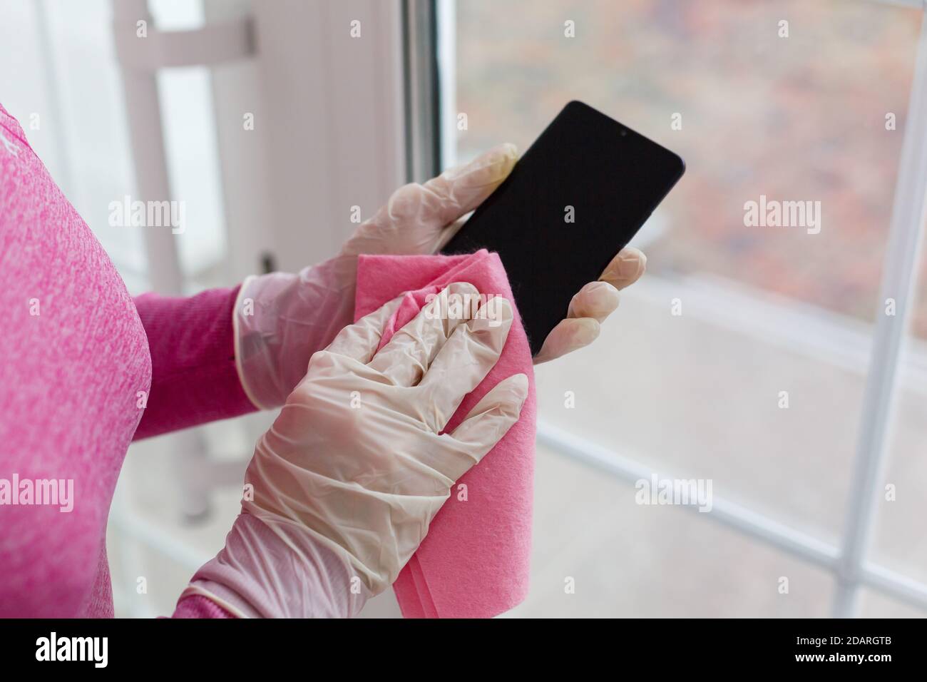 Cleaning the smartphone screen with a fiber cloth from dirt dust and ...