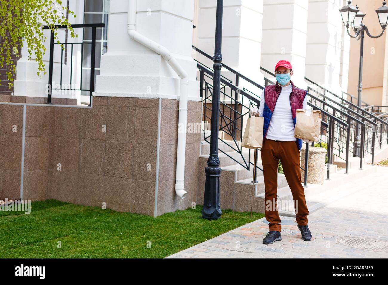 Man with face mask is delivering food and groceries during virus ...