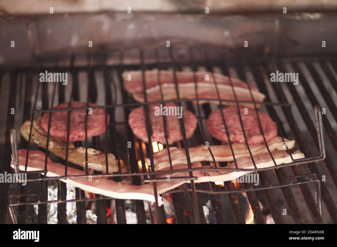 meat and vegetables cooking over fire on a grill Stock Photo - Alamy