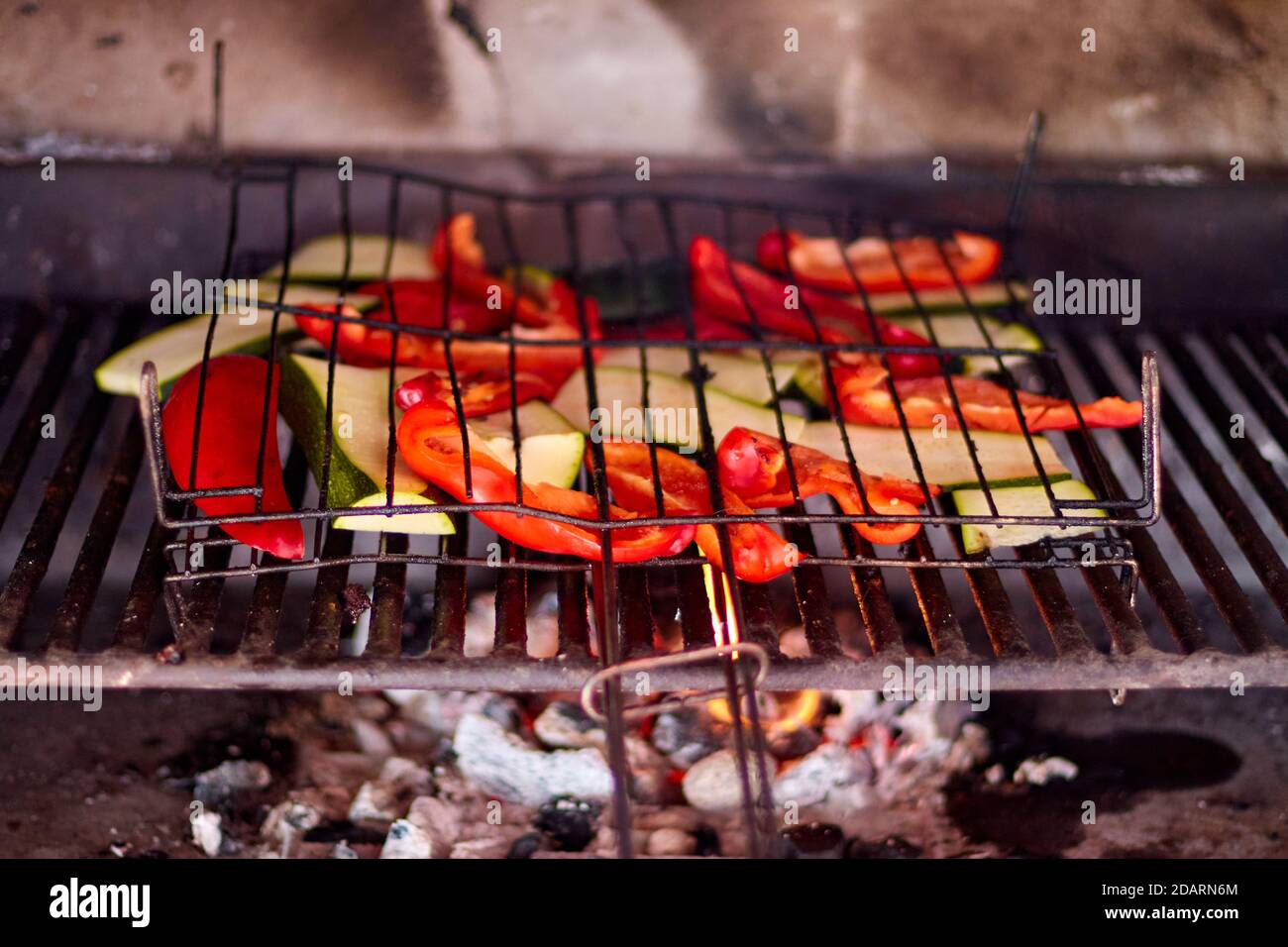 meat and vegetables cooking over fire on a grill Stock Photo - Alamy