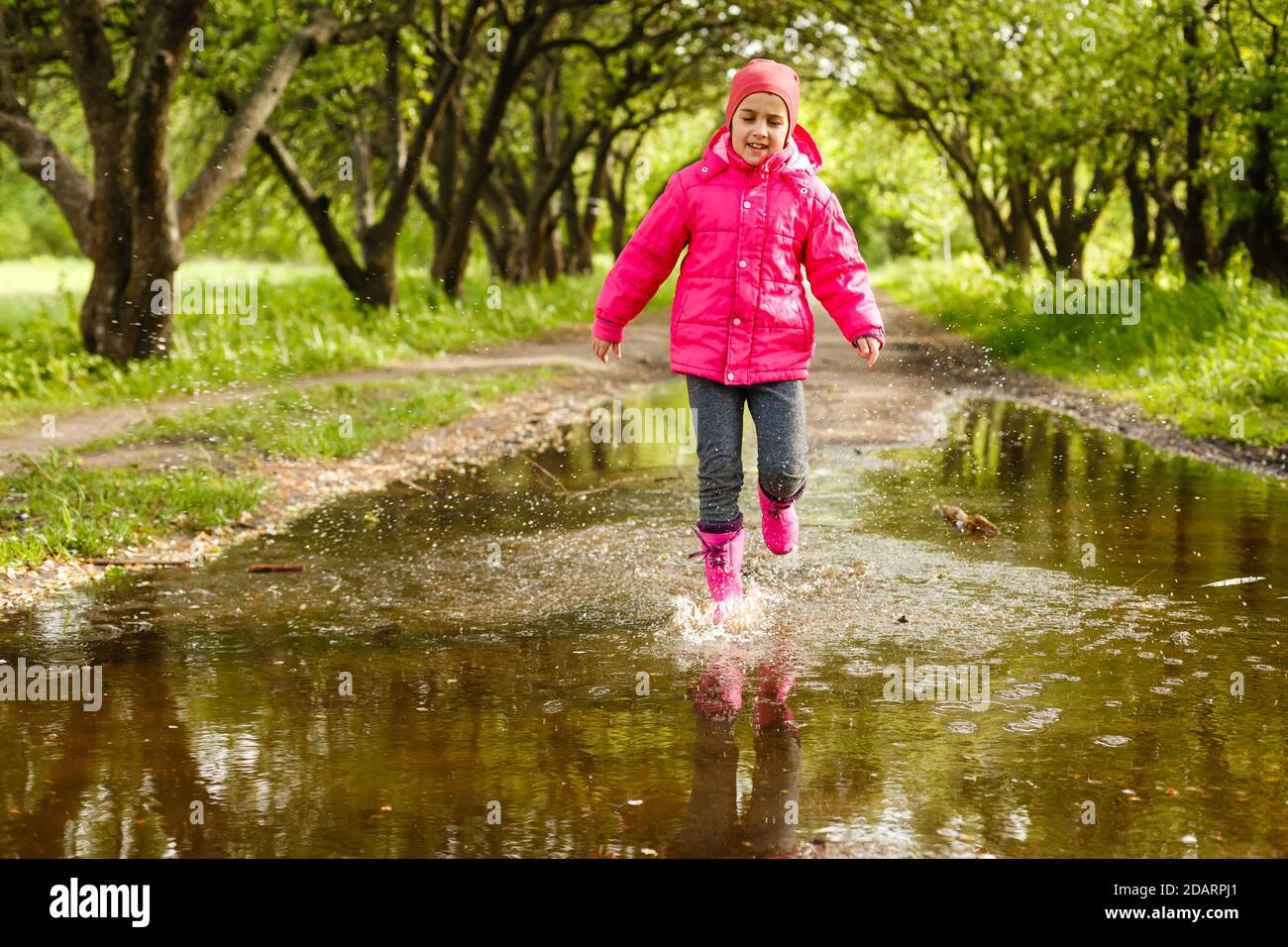 little girl riding bike in water puddle Stock Photo - Alamy