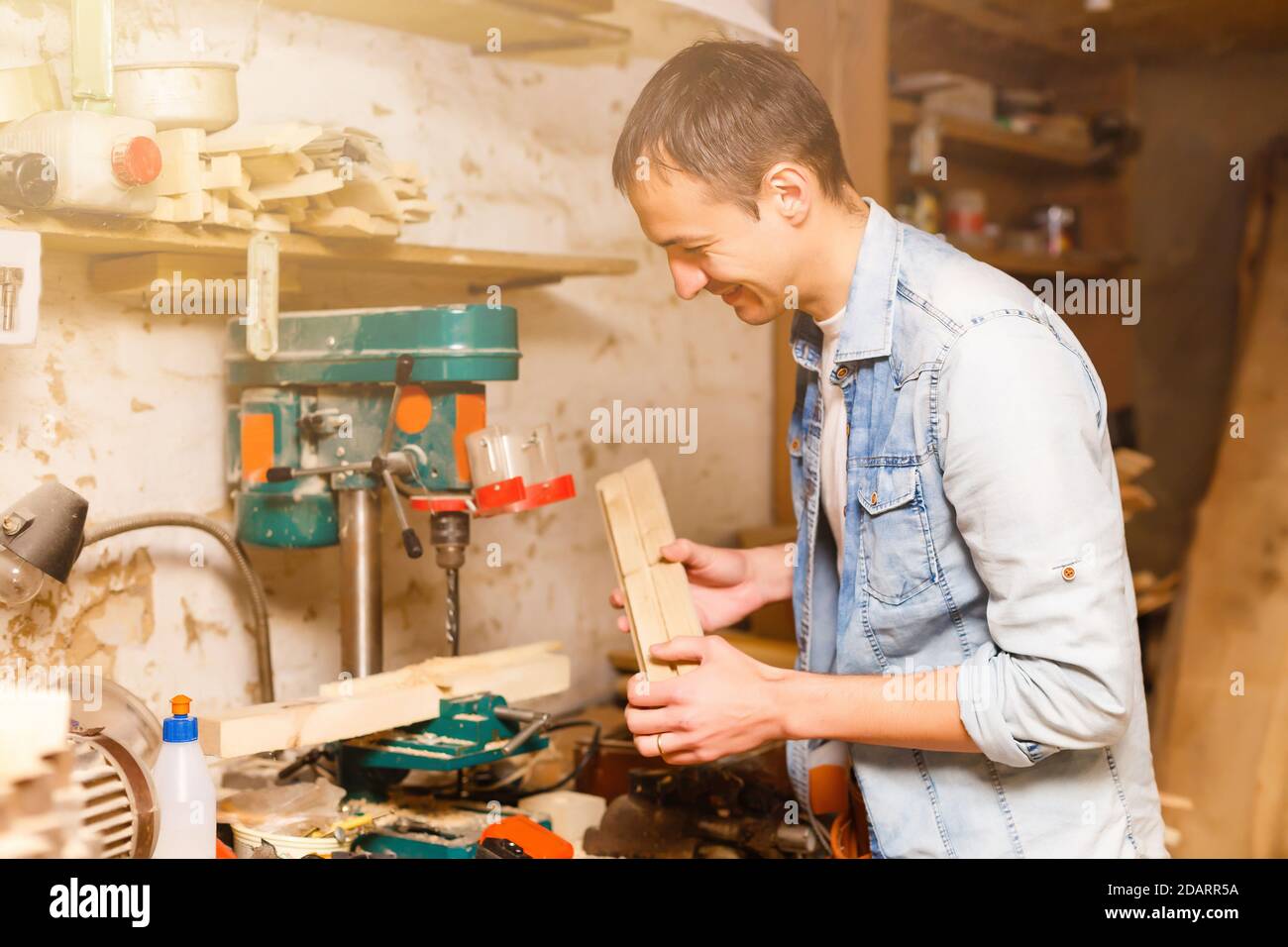 Carpenter works in a workshop for the production of vintage furniture ...