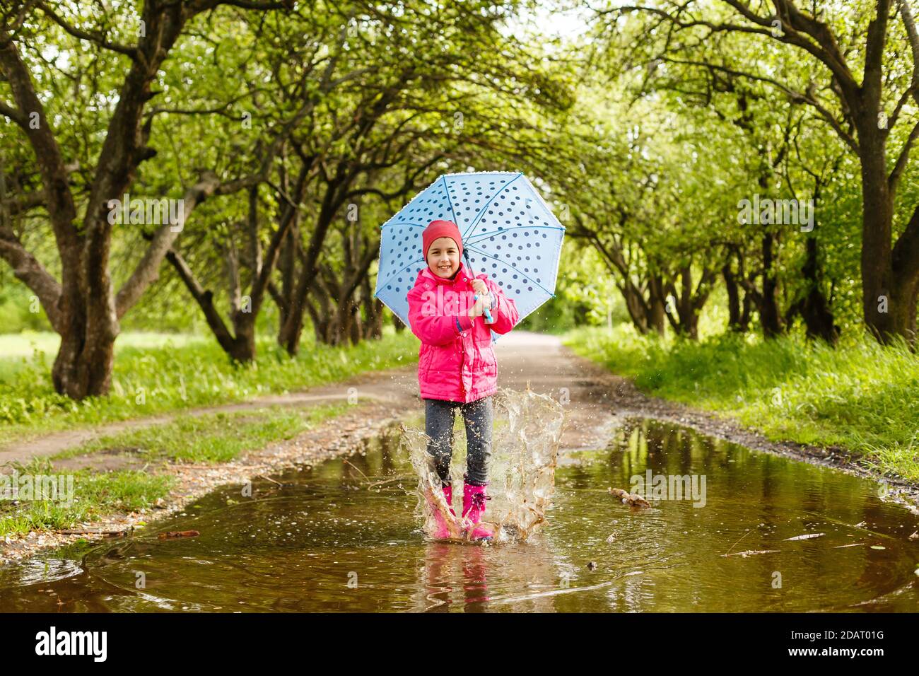 little girl riding bike in water puddle Stock Photo - Alamy