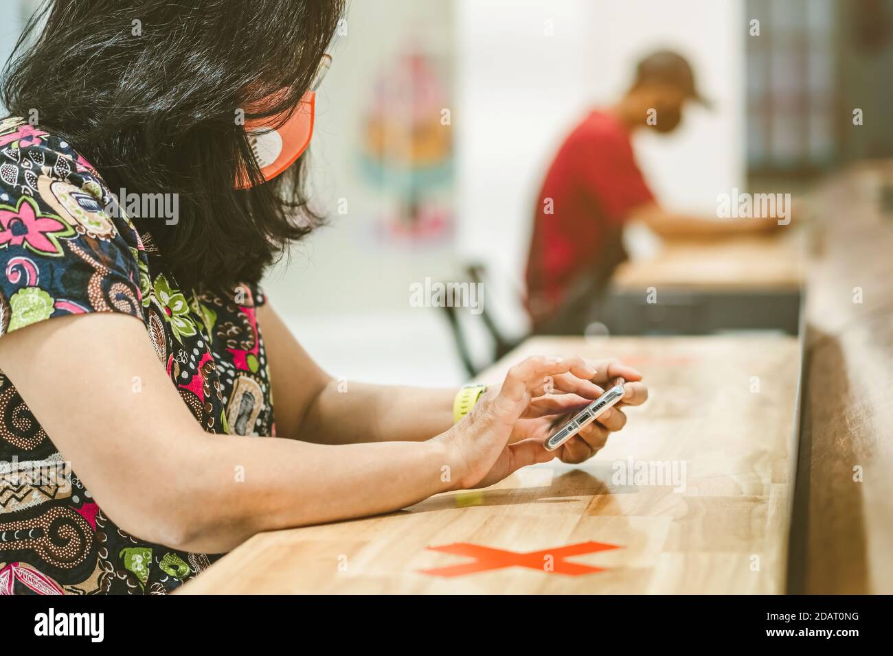 Woman using mobile phones for work with blurred image of alternative ...
