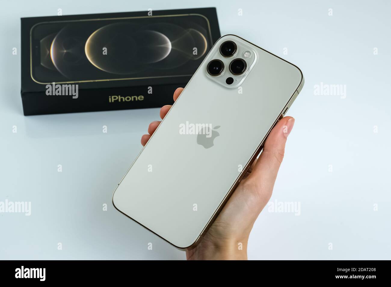 iPhone 12 Pro Max in the gold color in the hand of a customer Stock ...