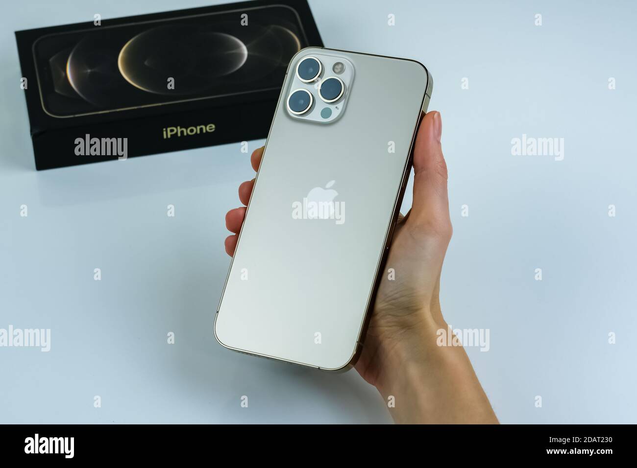 iPhone 12 Pro Max in the gold color in the hand of a customer Stock ...